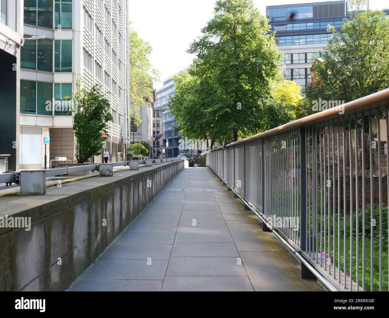 8 June 2023 - City of London, UK: Pavement walkway beside Roman wall ...