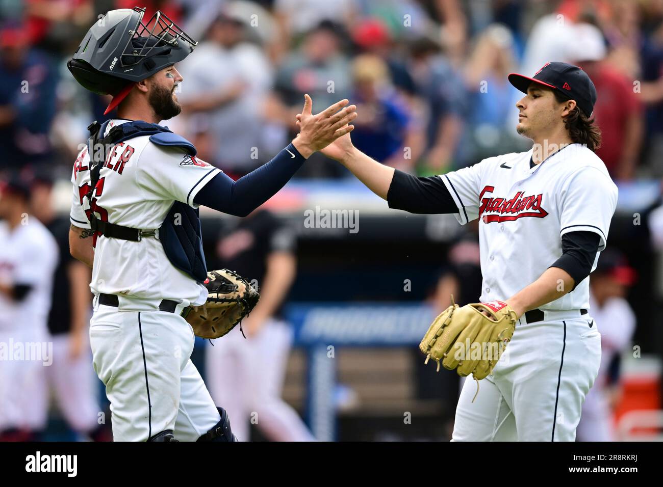 Cleveland Guardians catcher Cam Gallagher, left, and relief pitcher Eli ...