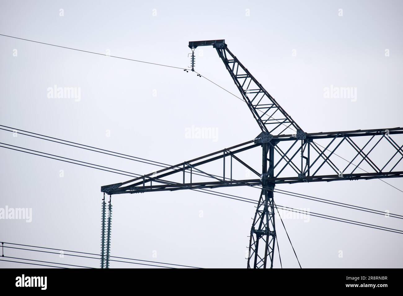High voltage tower with electric power lines divided by safe guard ...