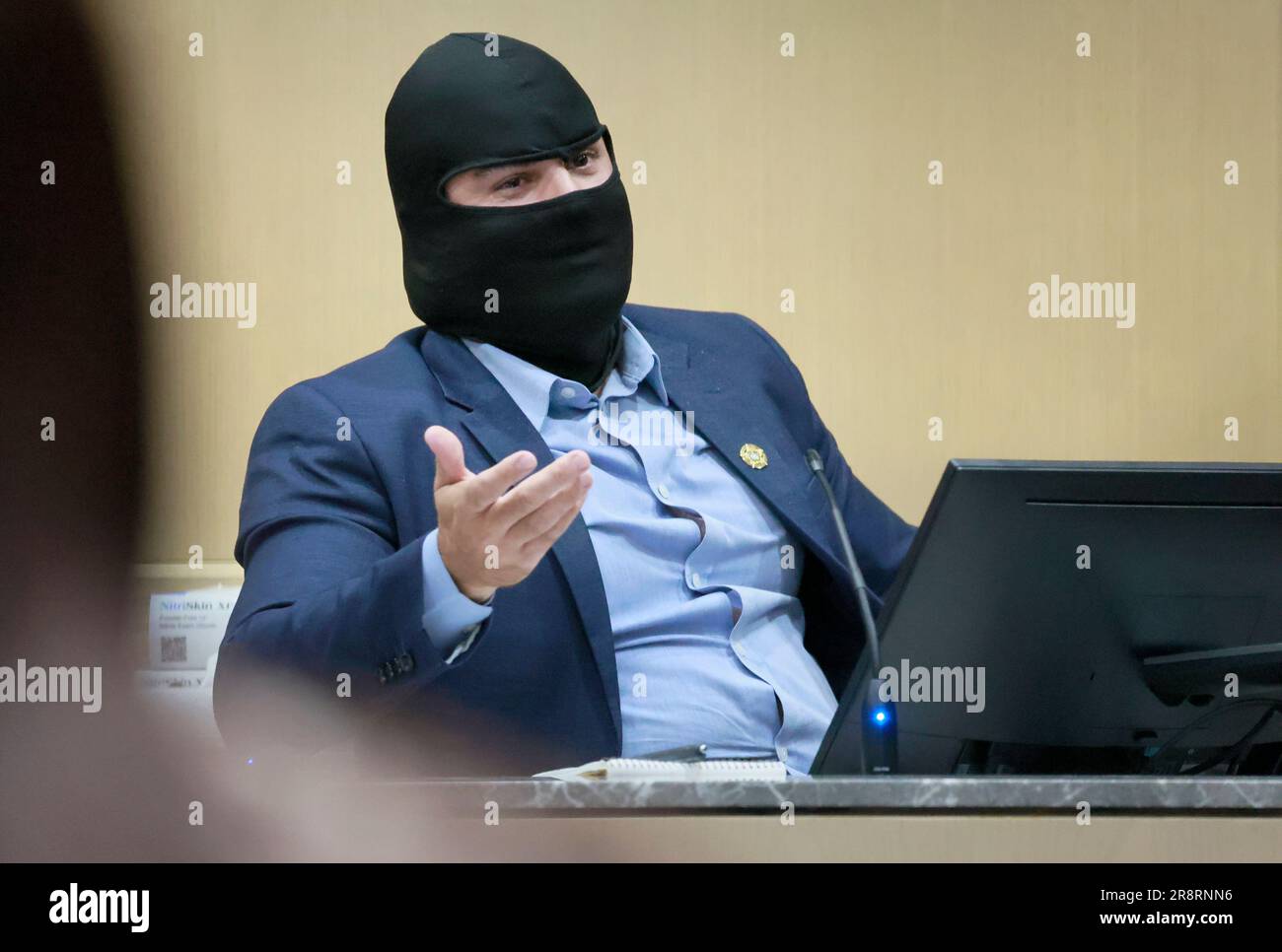 Broward Sheriff's Office Detective Danny Polo, whose face is concealed ...