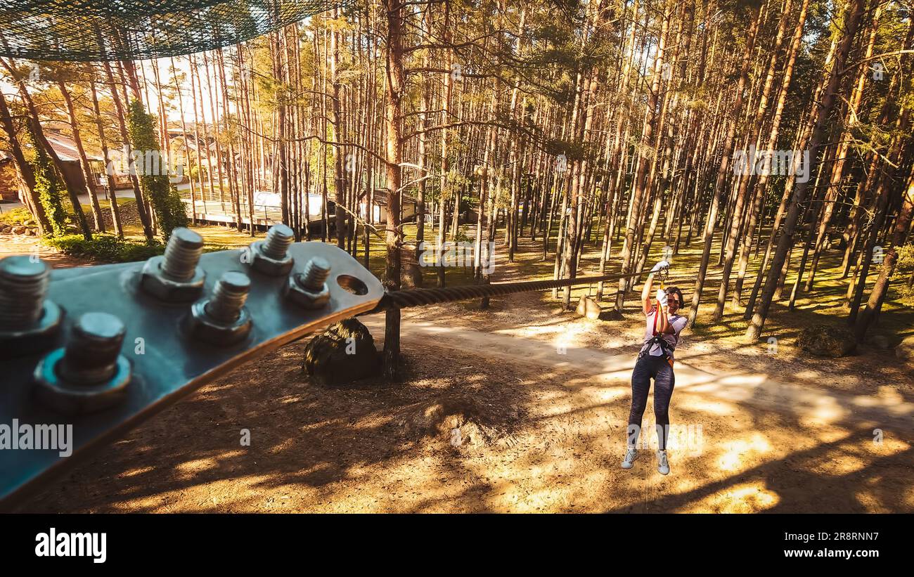 Palanga, Lithuania - 2023: young woman girl sliding along zipline in ...