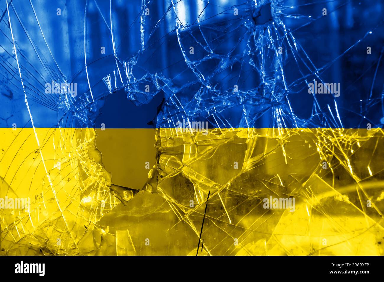 Bullet hole, cracks in the glass on a yellow-blue background. Ukraine ...
