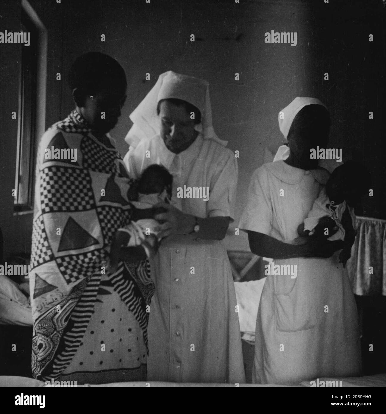 The Matron on her morning rounds stops at the maternity ward to see the ...