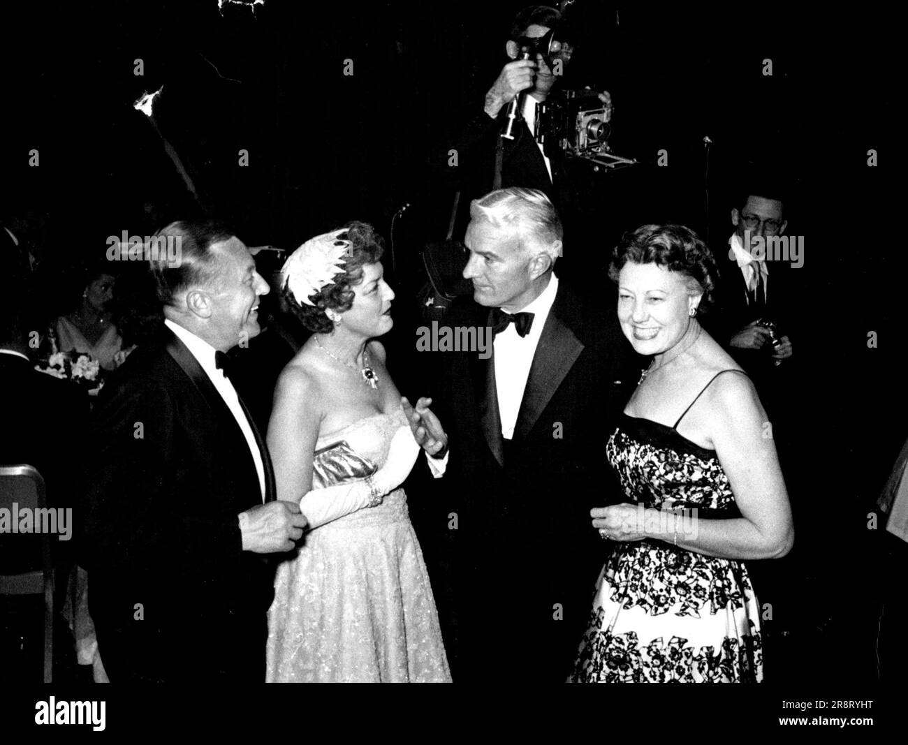 Norman Chandler receives congratulations from Gene Raymond (left) and ...