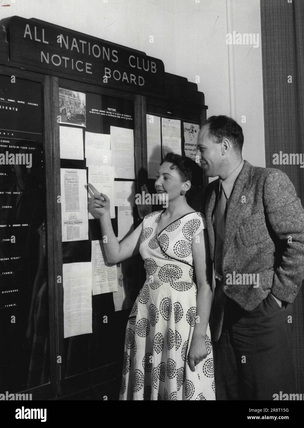 Pretty Anne Molle, a Lithuanian, points out a social notice on the club ...