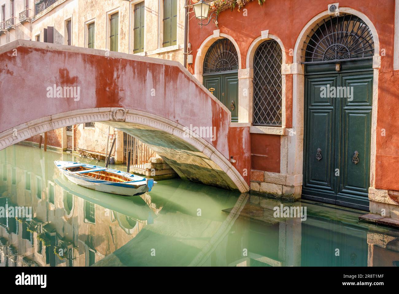Boat under the stone bridge in beautiful lighting in Venice, Italy ...