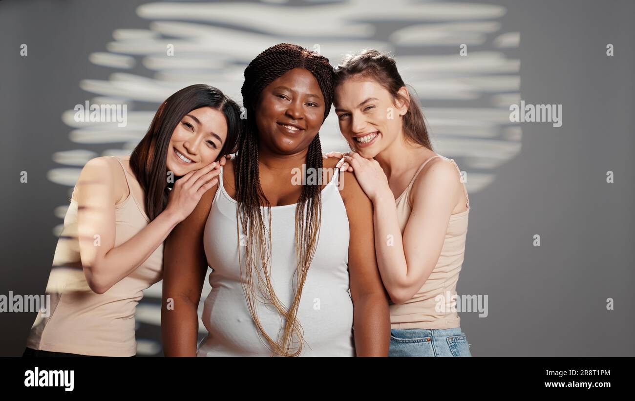 Healthy glowing ladies promoting self confidence in studio, having ...