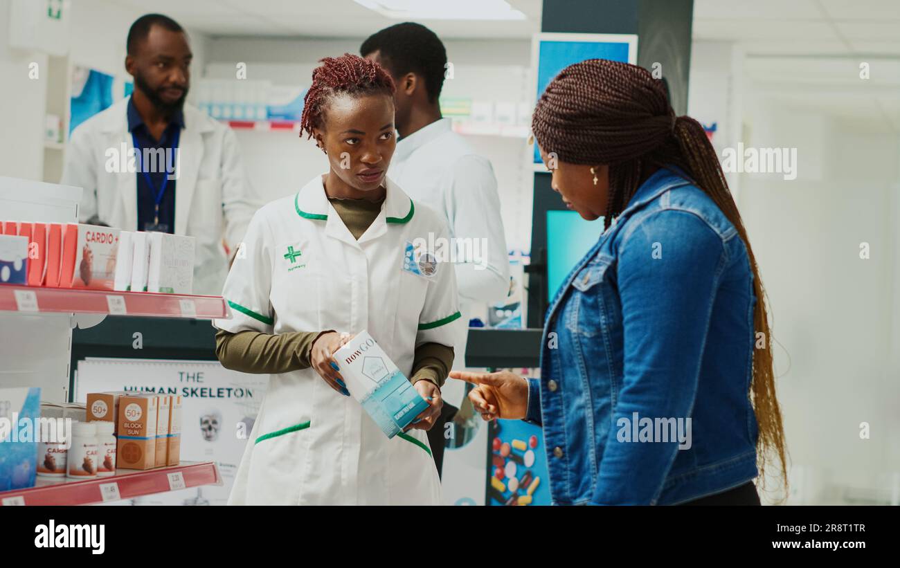 Pharmacist talking to patients in store hi-res stock photography and ...