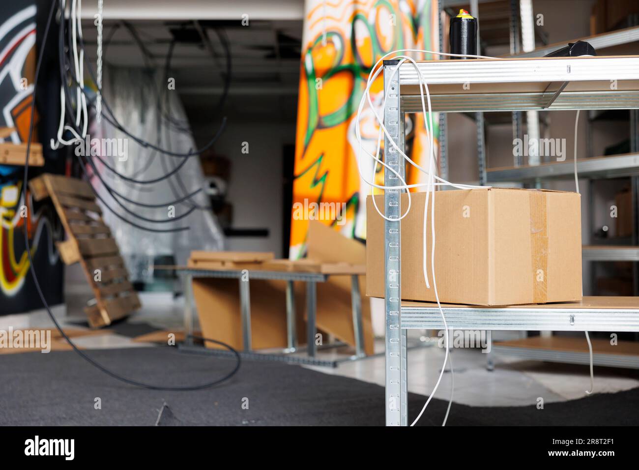 Ruined damaged warehouse with graffiti art on walls, dirty old building ...