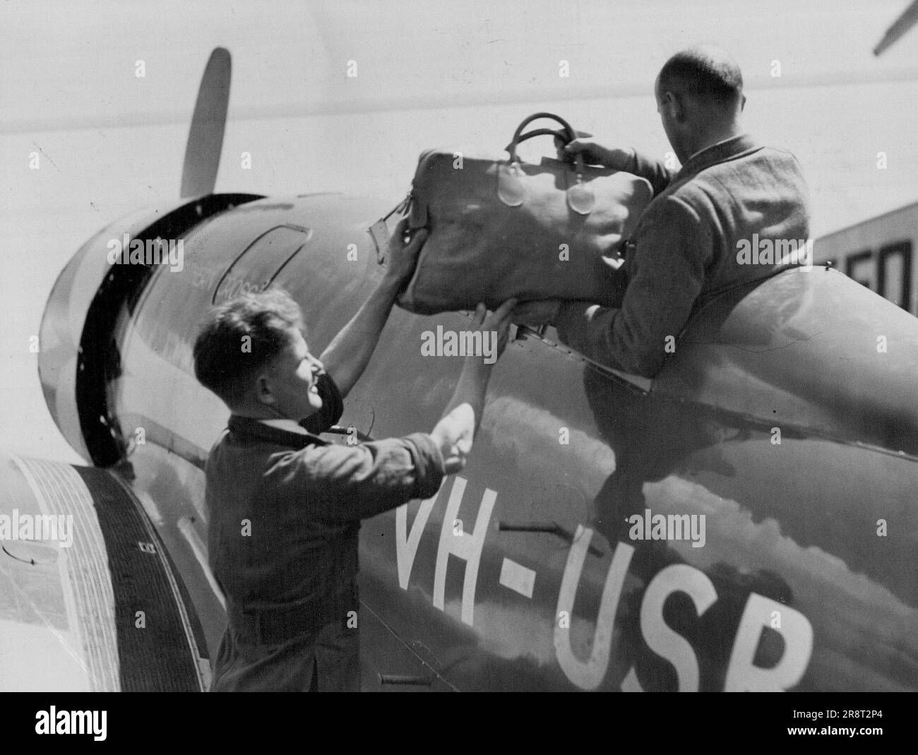 Merchanie passing things to co-pilot Capt P.G. Taylor before they left ...