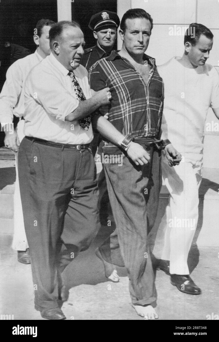 Actor Lawrence Tierney, his hands bound by straps, is taken to a ...