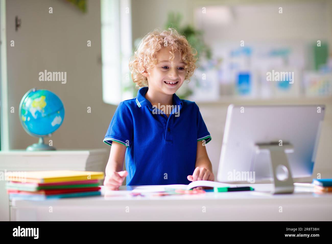 Child doing homework on computer. Online class. Homeschooling and ...