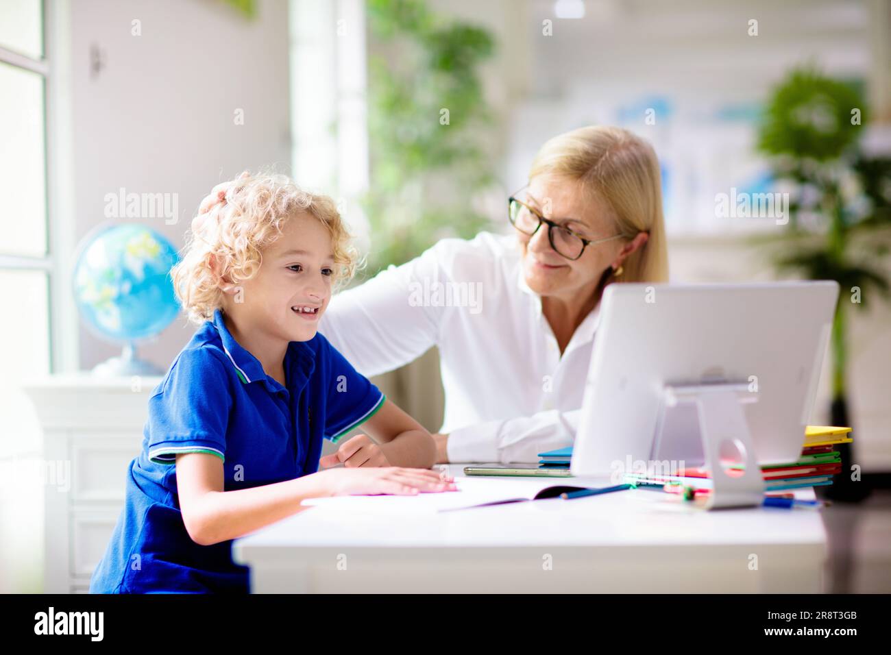 Child doing homework on computer. Online class. Homeschooling and ...