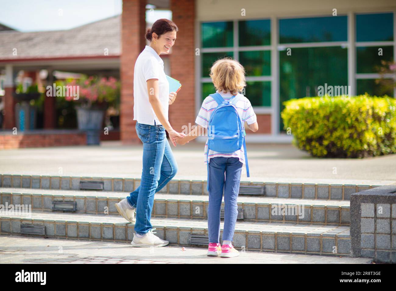Mother bringing child to school. Parents pick up little boy after class ...
