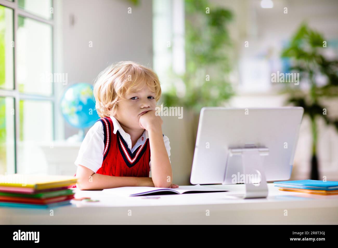 Child doing homework on computer. Online class. Homeschooling and ...