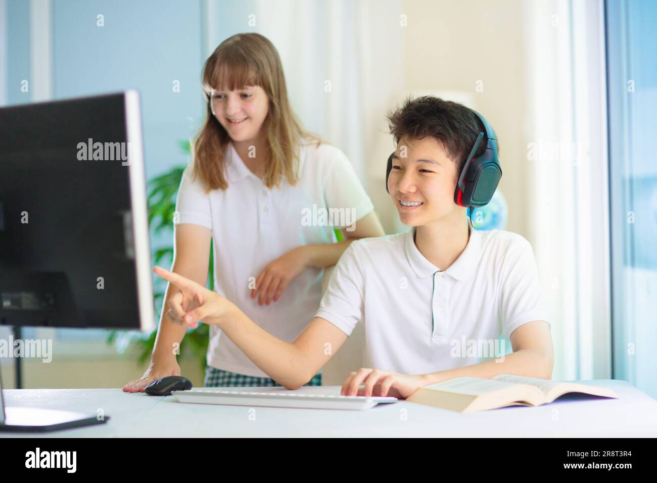 Kids in school class. Children working on school project. IT, coding and computer lesson ...