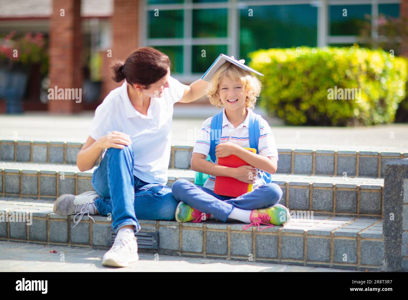 Mother bringing child to school. Parents pick up little boy after class ...