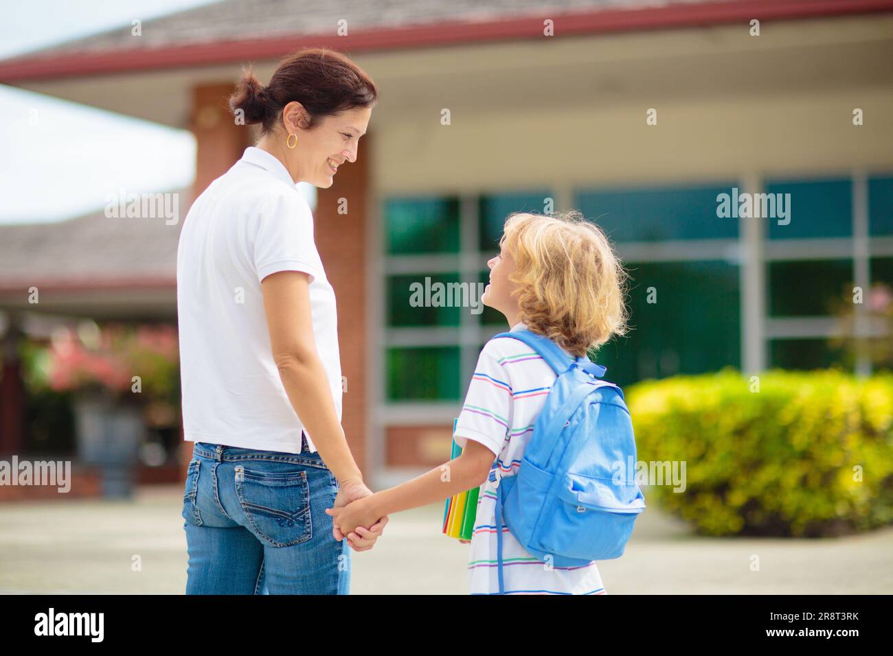 Mother bringing child to school. Parents pick up little boy after class ...