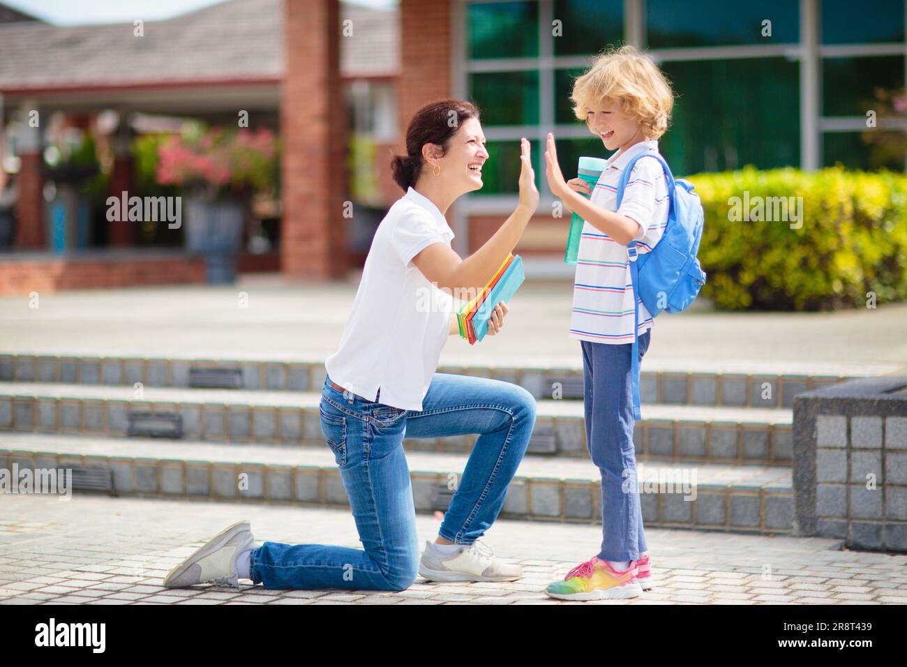 Mother bringing child to school. Parents pick up little boy after class ...