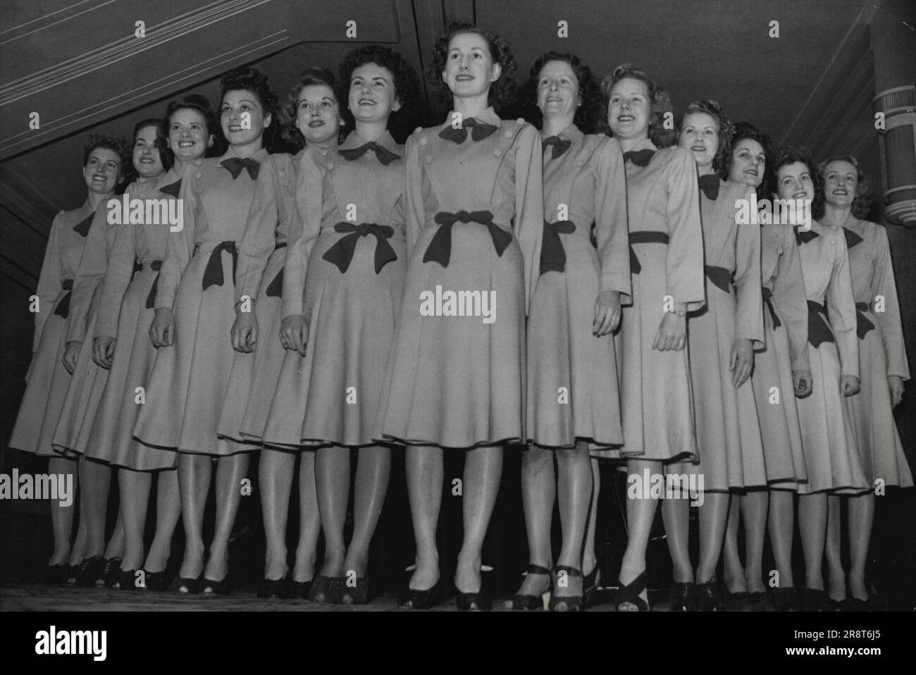 Line-up of neat, smartly uniformed usherettes, ready to begin the day ...