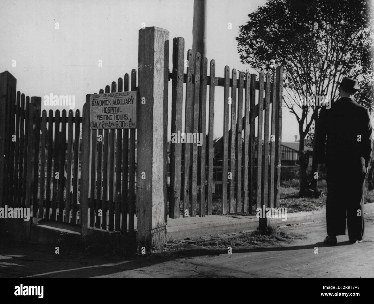 A broken gate set in an unpainted paling fence is the depressing ...