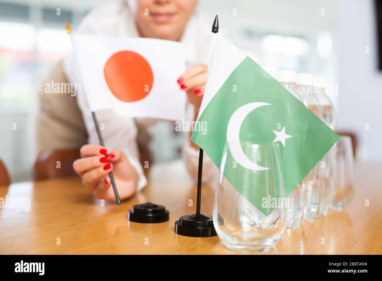 Little flag of Pakistan on table and flag of Japan put next to it by ...