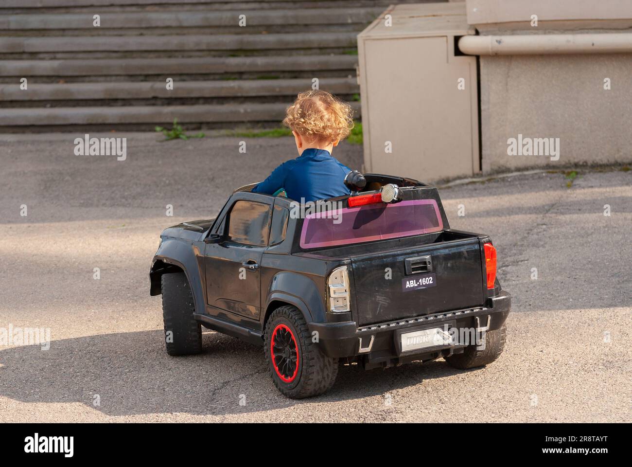 Georgia, Tbilisi - May 8, 2021: Little boy driving big toy car Stock ...