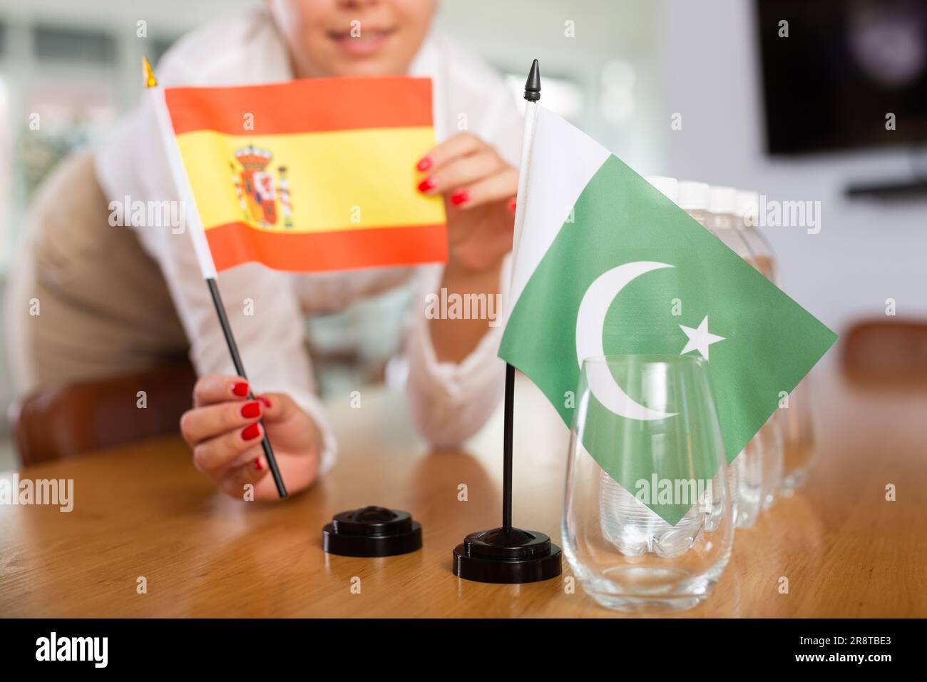 Little flag of Pakistan on table and flag of Spain put next to it by ...