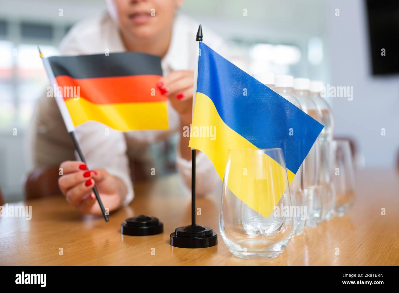 Unrecognizable girl sets midget flags of Ukraine and Germany before ...