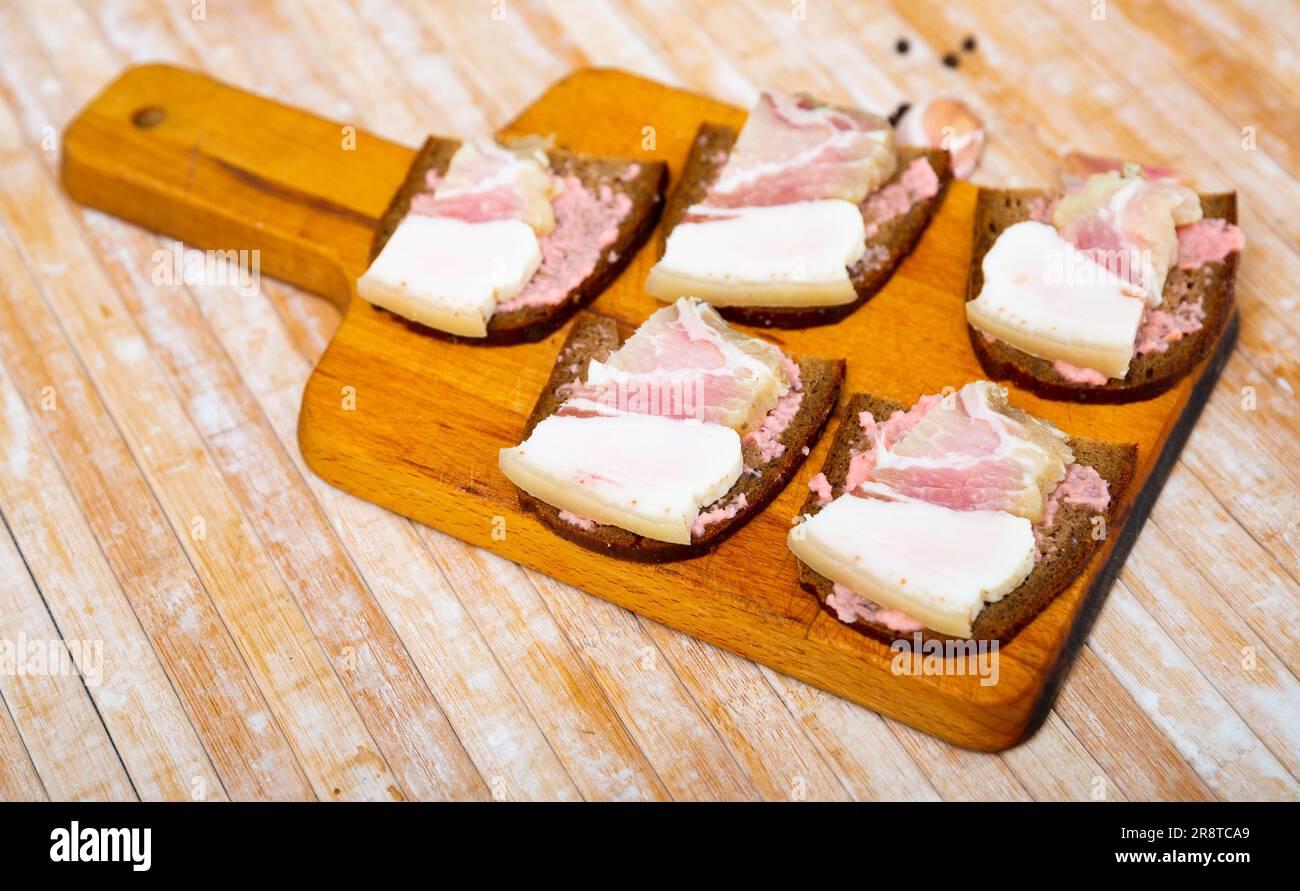 Snack for vodka, homemade salo with bread and horseradish Stock Photo ...