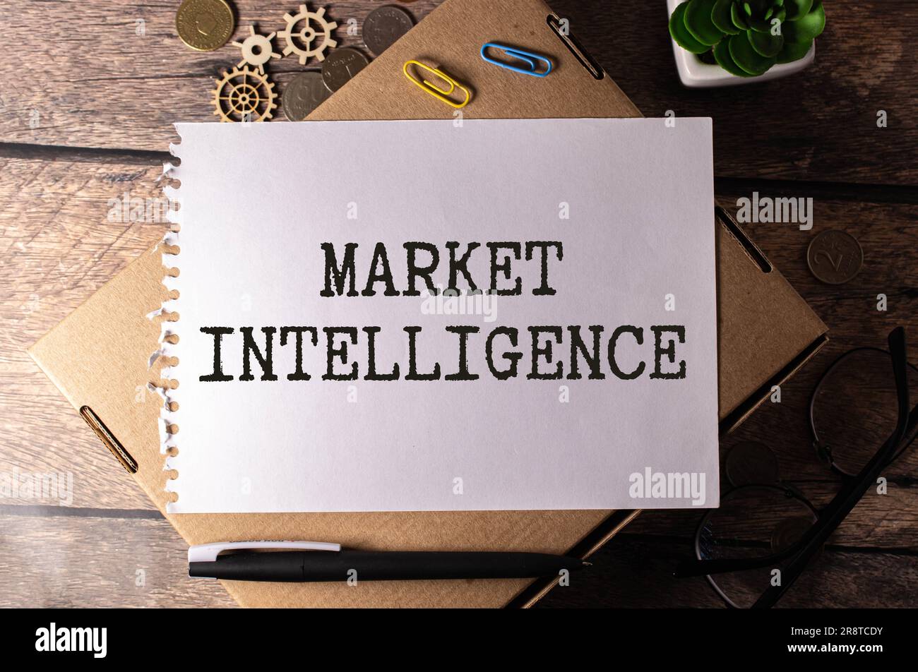 Text MARKET INTELLIGENCE on a Office desk table with keyboard, notepad ...