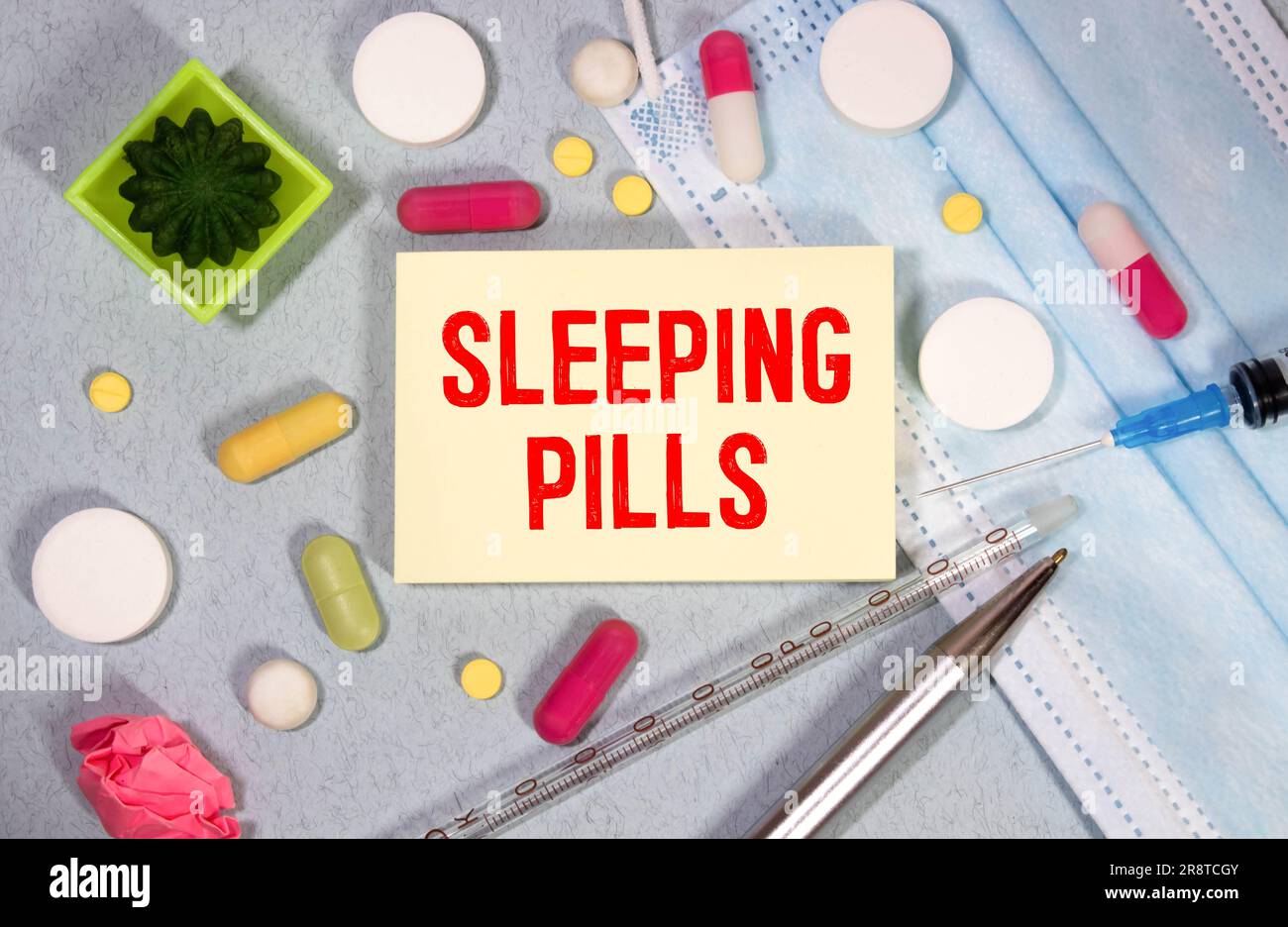 Notepad with text SLEEPING PILLS on a white background. Medical concept ...