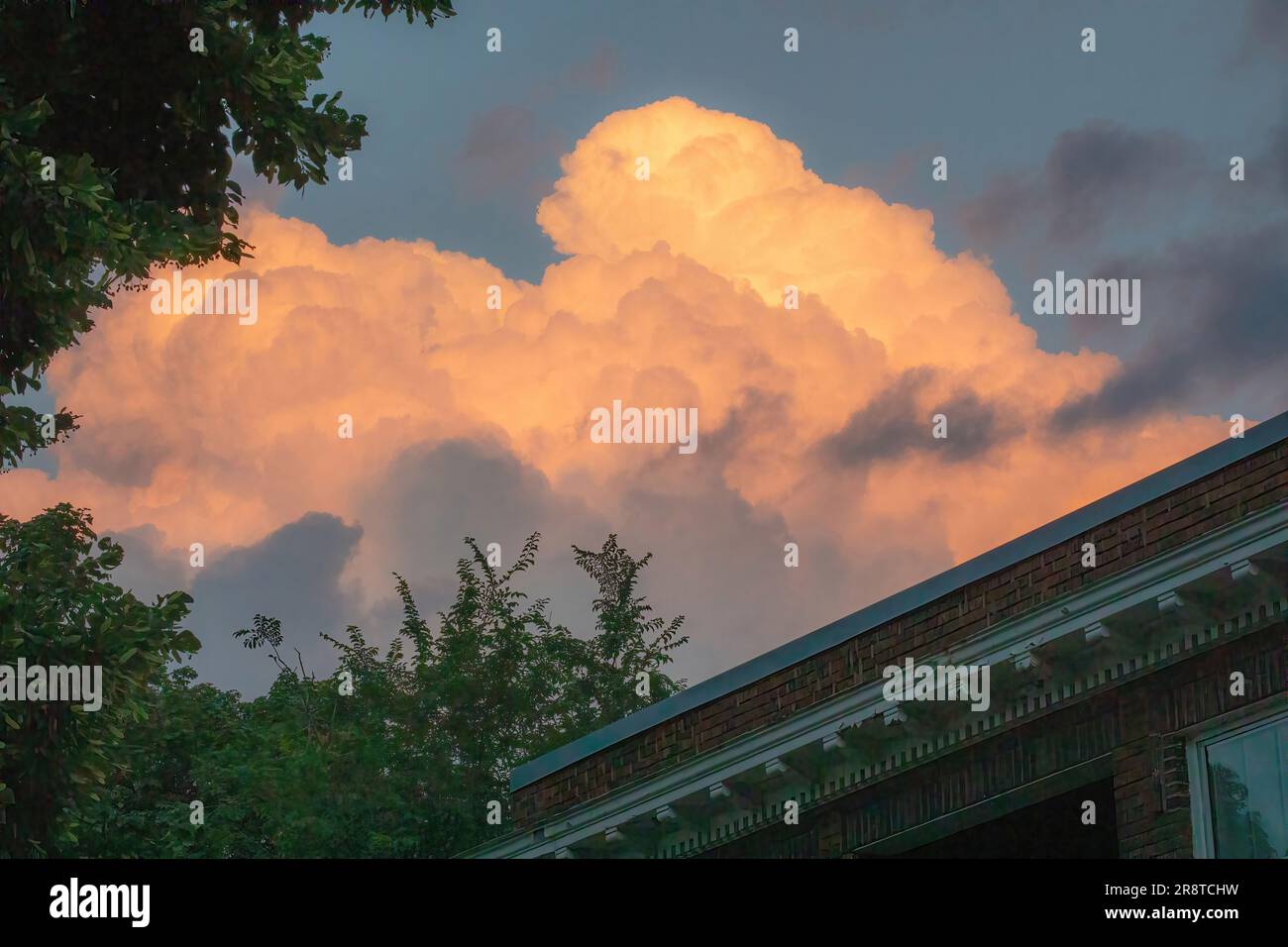 Beautiful fluffy cumulus pink clouds over an older home on Portland Ave ...