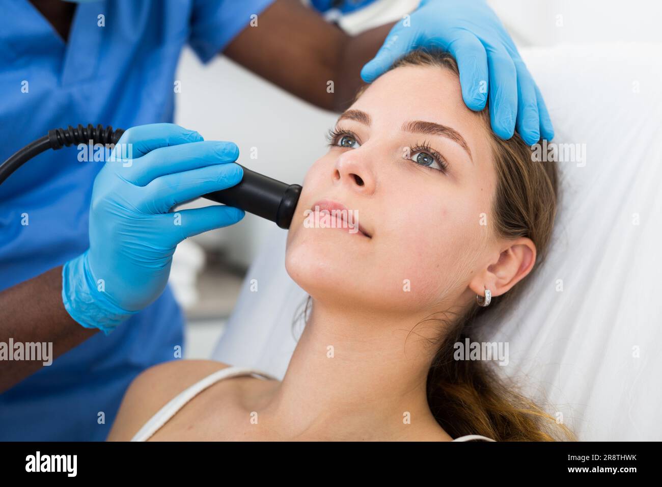 Female receiving face skin rf lifting procedure in aesthetic ...