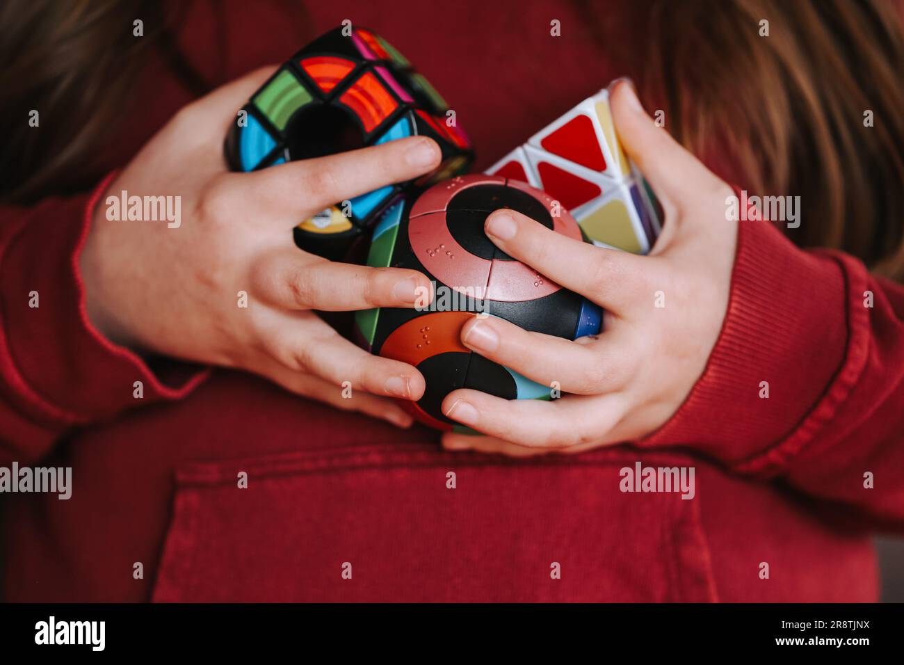 Educational toys. Puzzles of different shapes in childrens hands ...