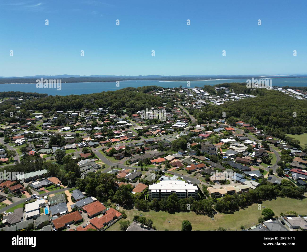 An aerial view of stunning suburbs, with houses and a sea in the ...