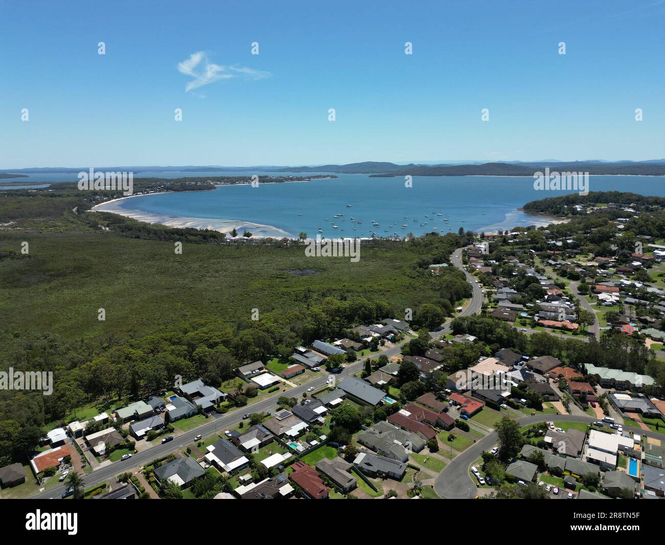 An aerial view of stunning suburbs, with houses and a sea in the ...