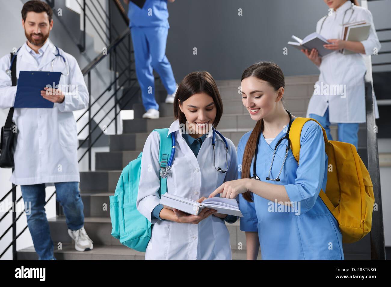 Medical students wearing uniforms on staircase in college, space for ...