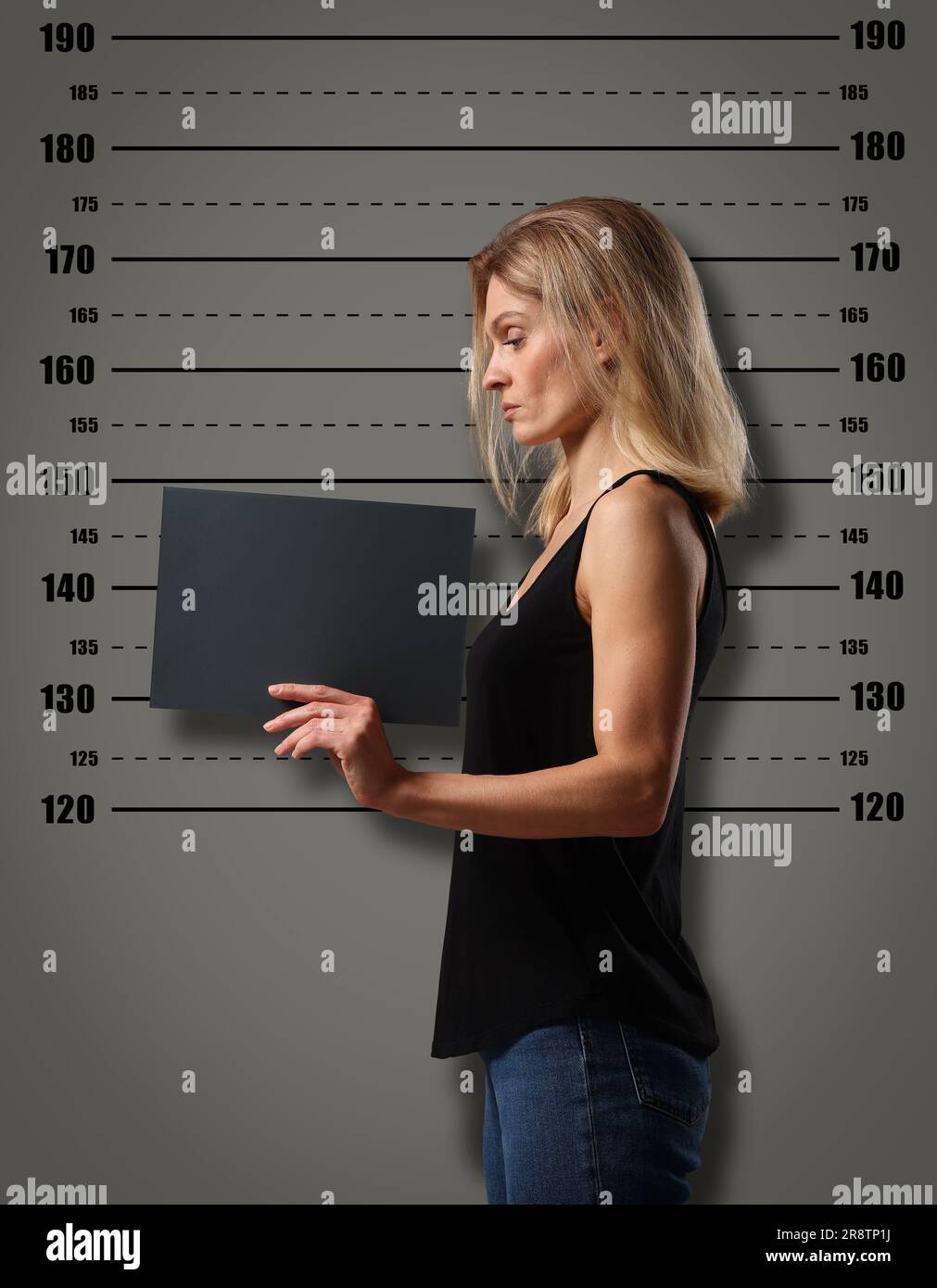 Criminal mugshot. Arrested woman with blank card against height chart ...