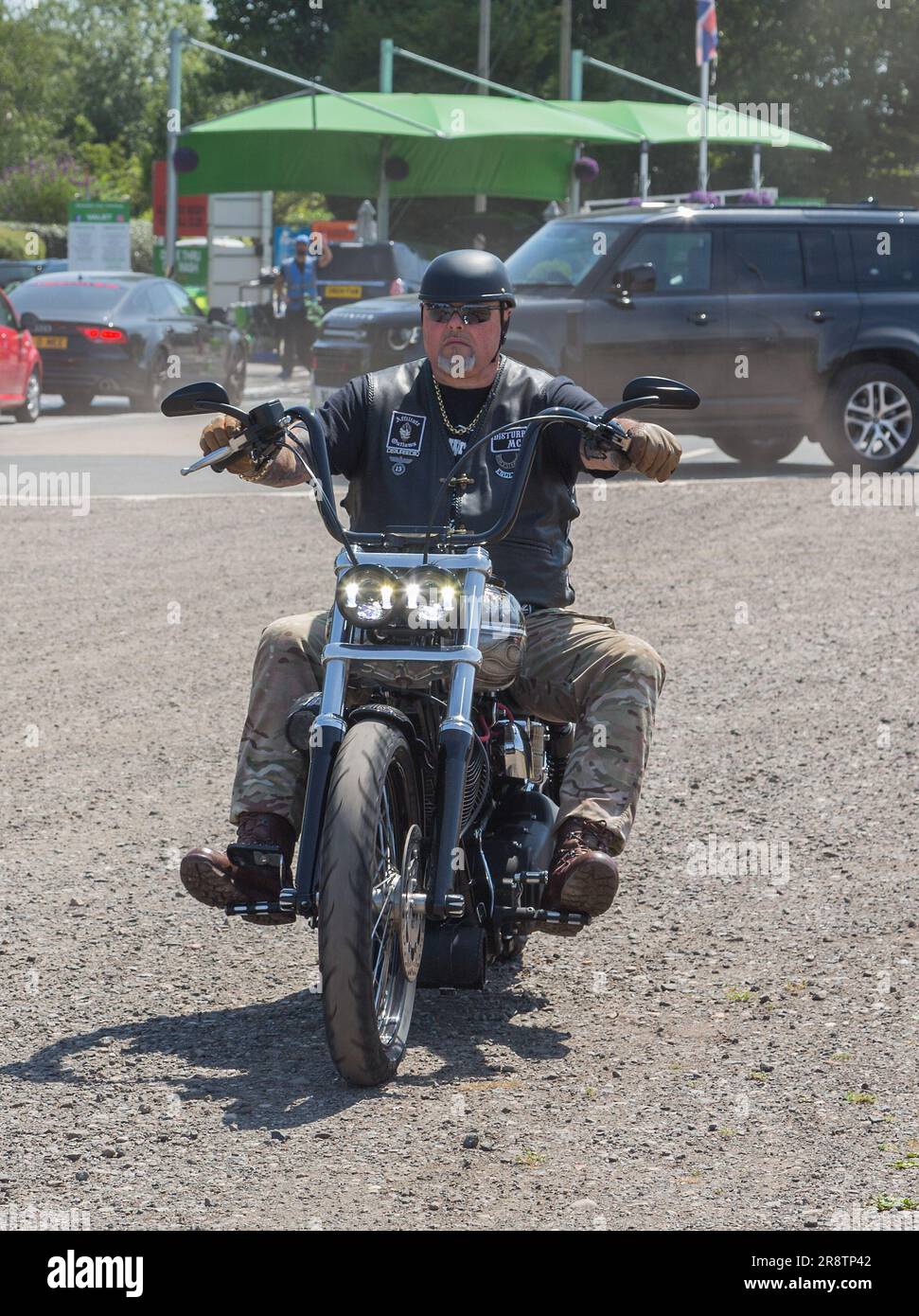 A members of a Motorcycle Club arriving at a motorcycle rally. A biker ...
