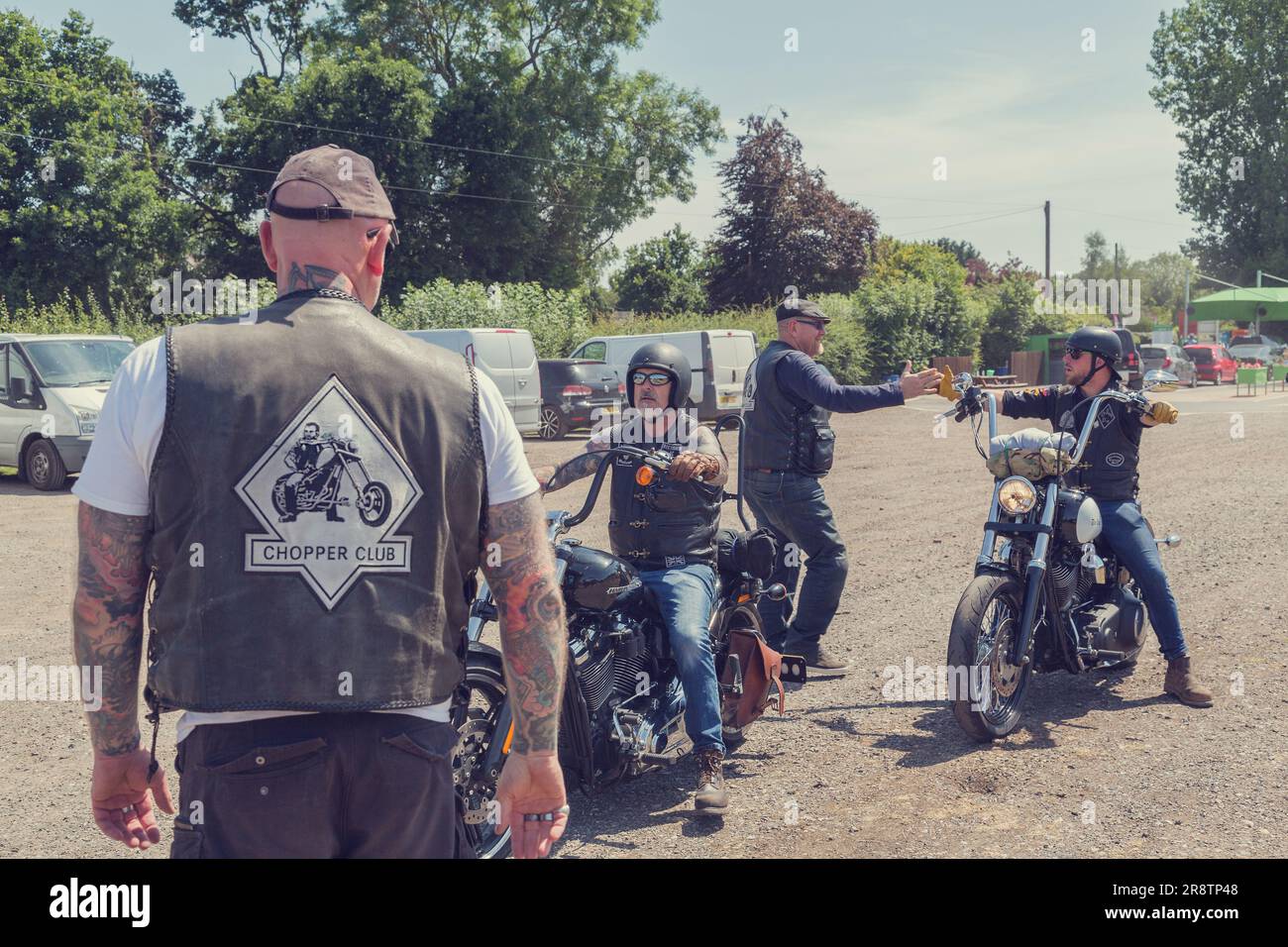 Members of a Motorcycle Club arriving at a motorcycle rally. Bikers being greeted as they arrive ...