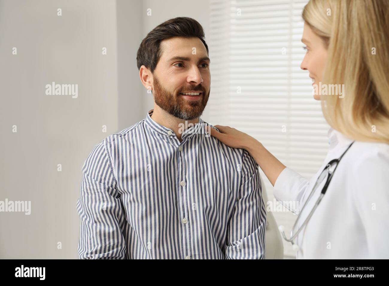Patient having appointment with doctor in clinic Stock Photo - Alamy