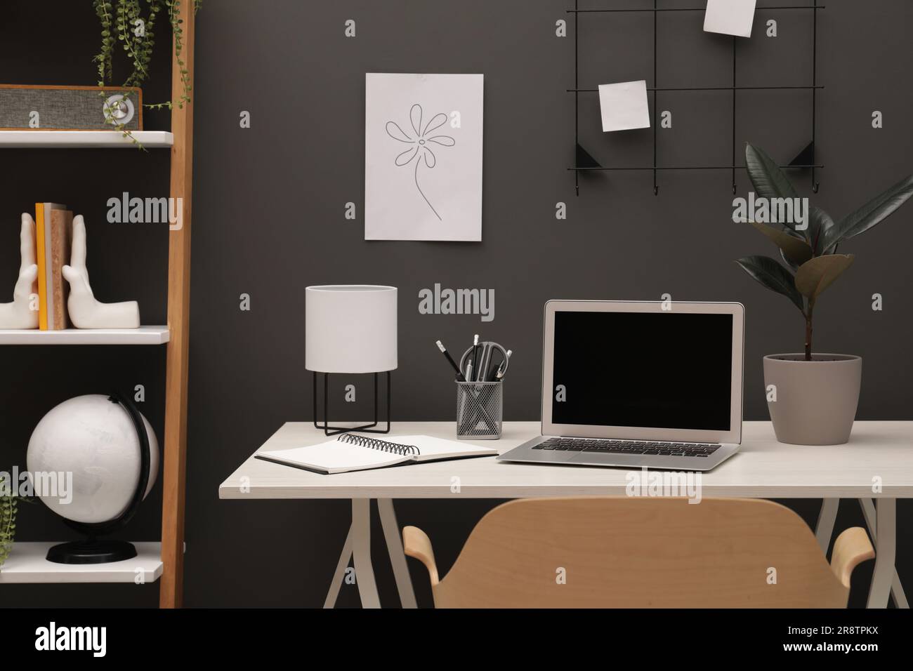 Cozy workplace with laptop and stationery on desk at home Stock Photo ...