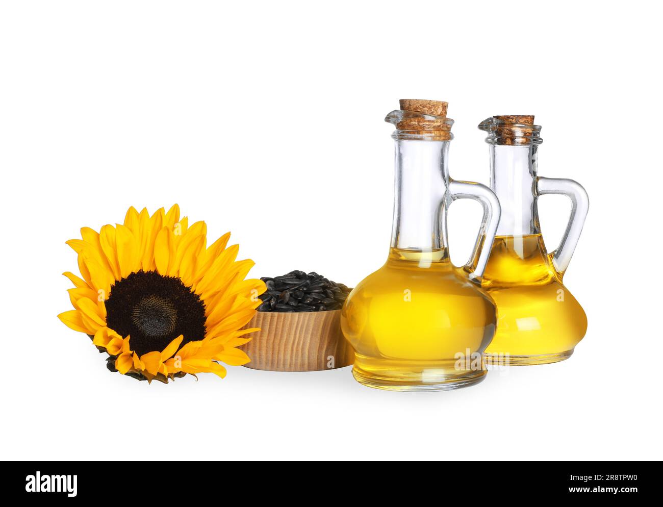 Sunflower cooking oil, seeds and yellow flowers on white background ...