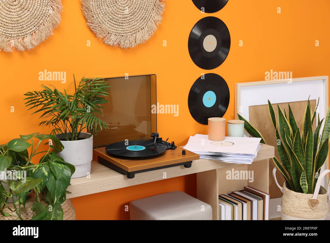 Stylish turntable with vinyl record on console table in cozy room Stock ...