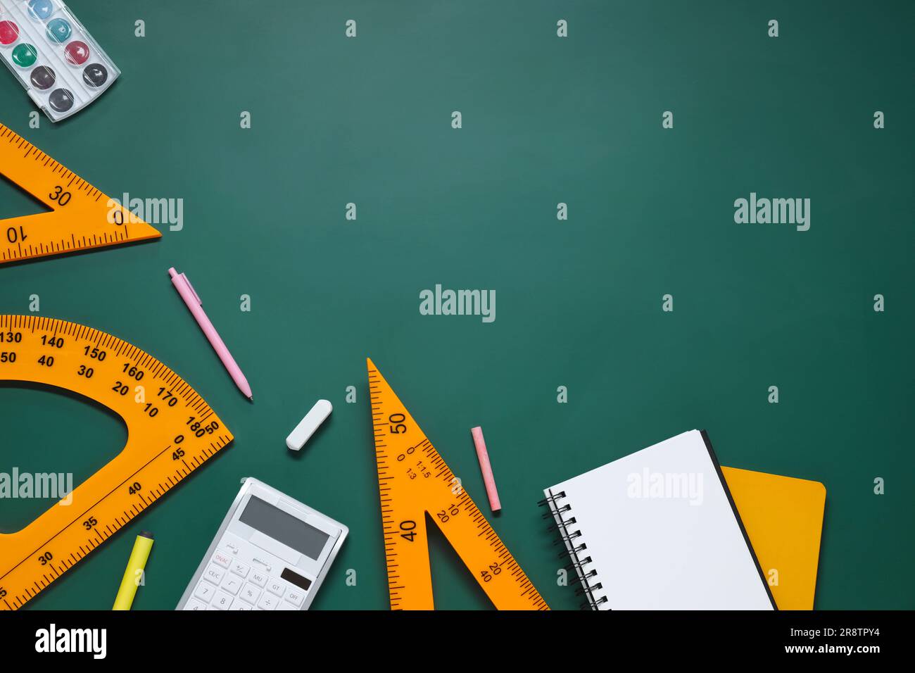 Flat lay composition with protractor, triangle and stationery on green ...