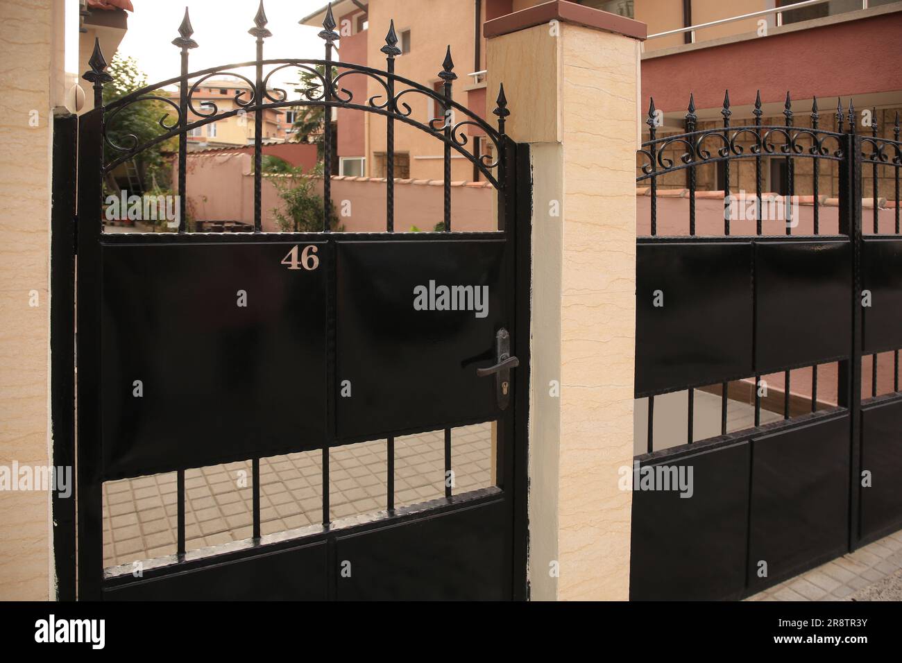 Plate with house number 46 on metal fence Stock Photo - Alamy