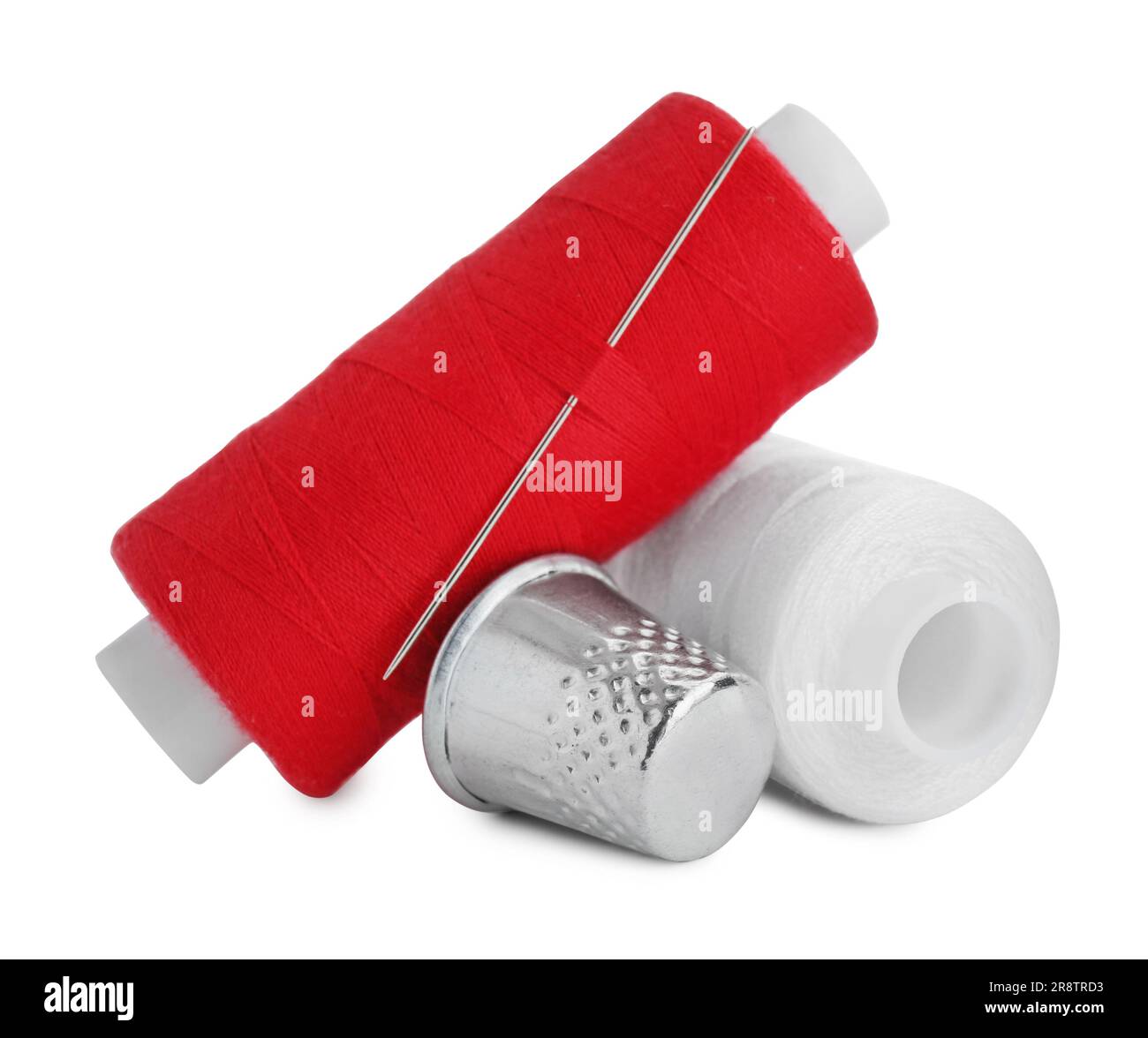 Thimble and spools of sewing threads with needle isolated on white ...