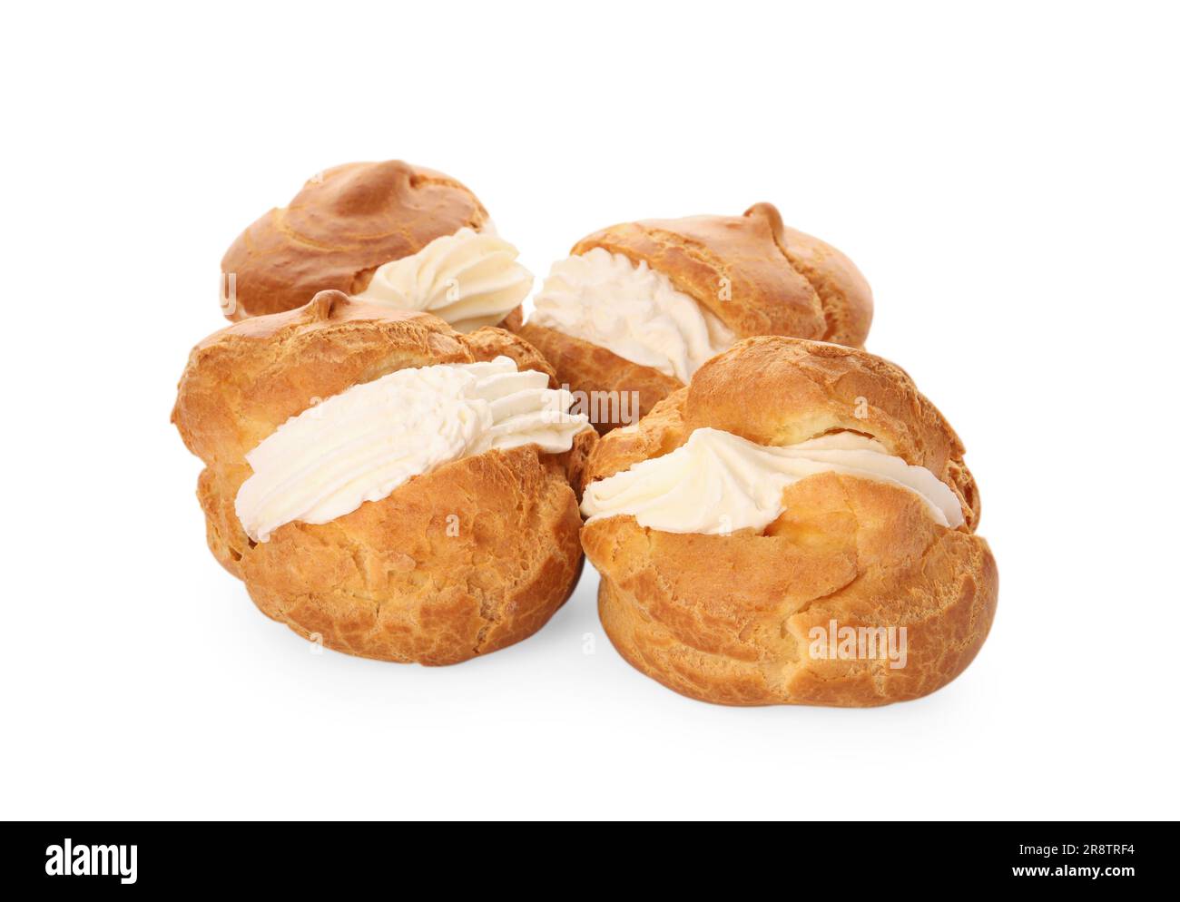 Delicious profiteroles with cream filling on white background Stock ...