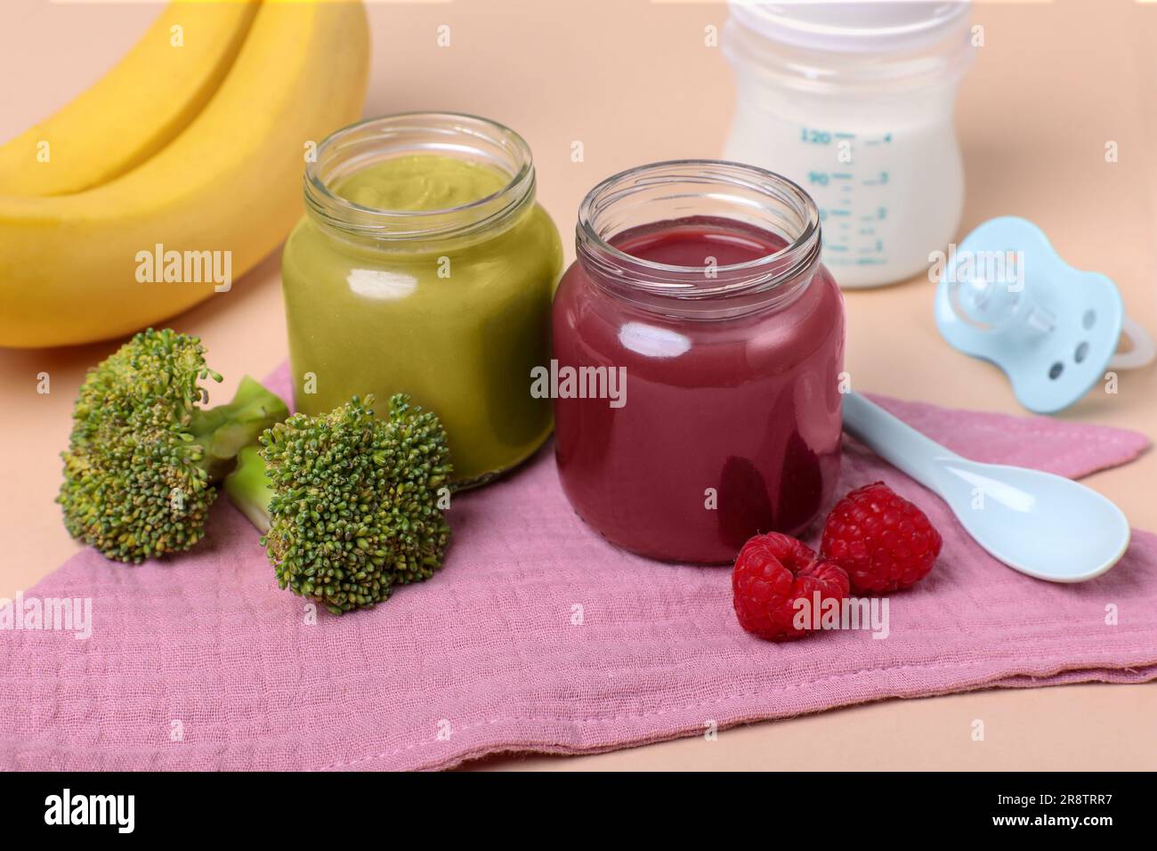 Healthy baby food, ingredients and spoon on pale pink background Stock ...